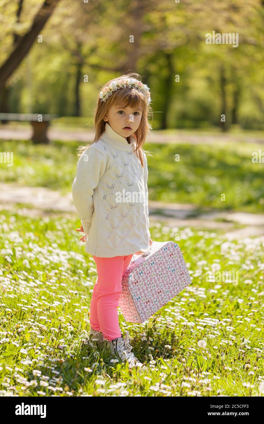 a little girl poses with her suitcase Stock Photo - Alamy