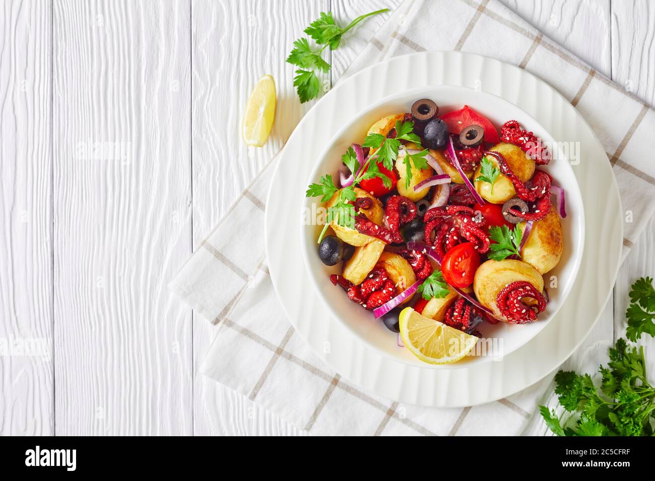 Asian marinated baby octopuses with young potatoes sprinkled with ...