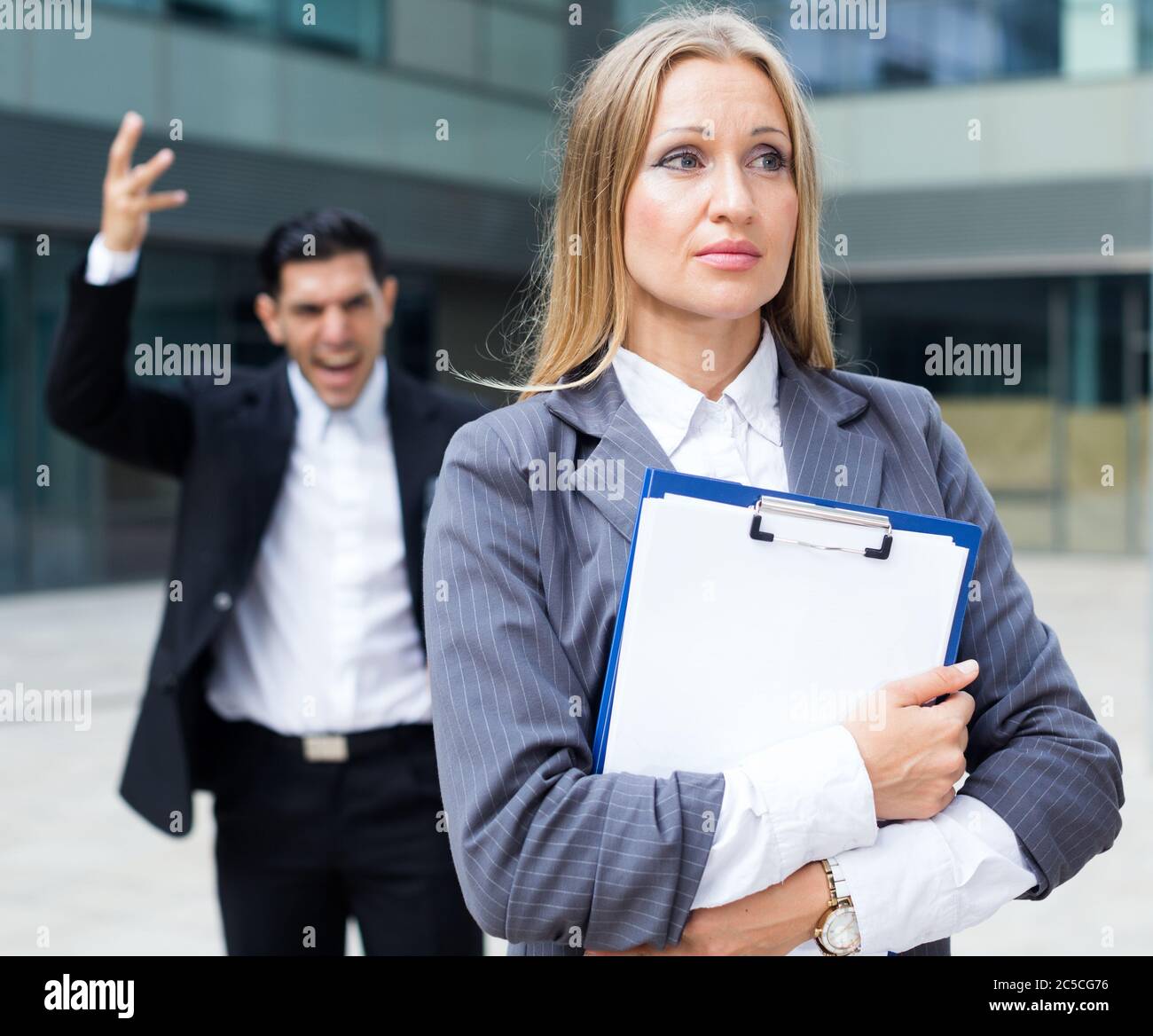 Female employee is upset with the reprimand of boss near office Stock ...