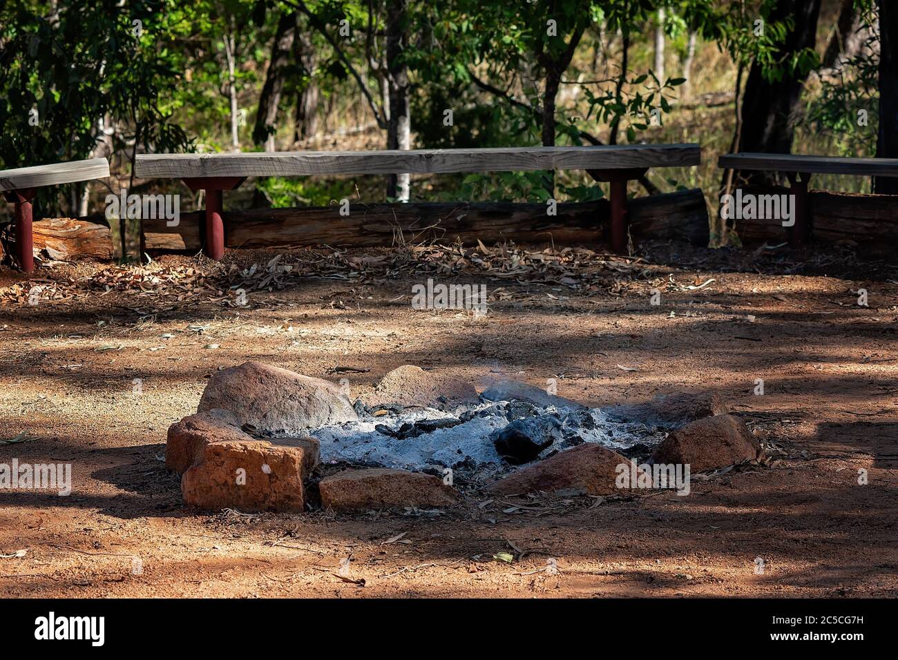 The cold ash of a campfire at an Australian outback bush tourist park ...