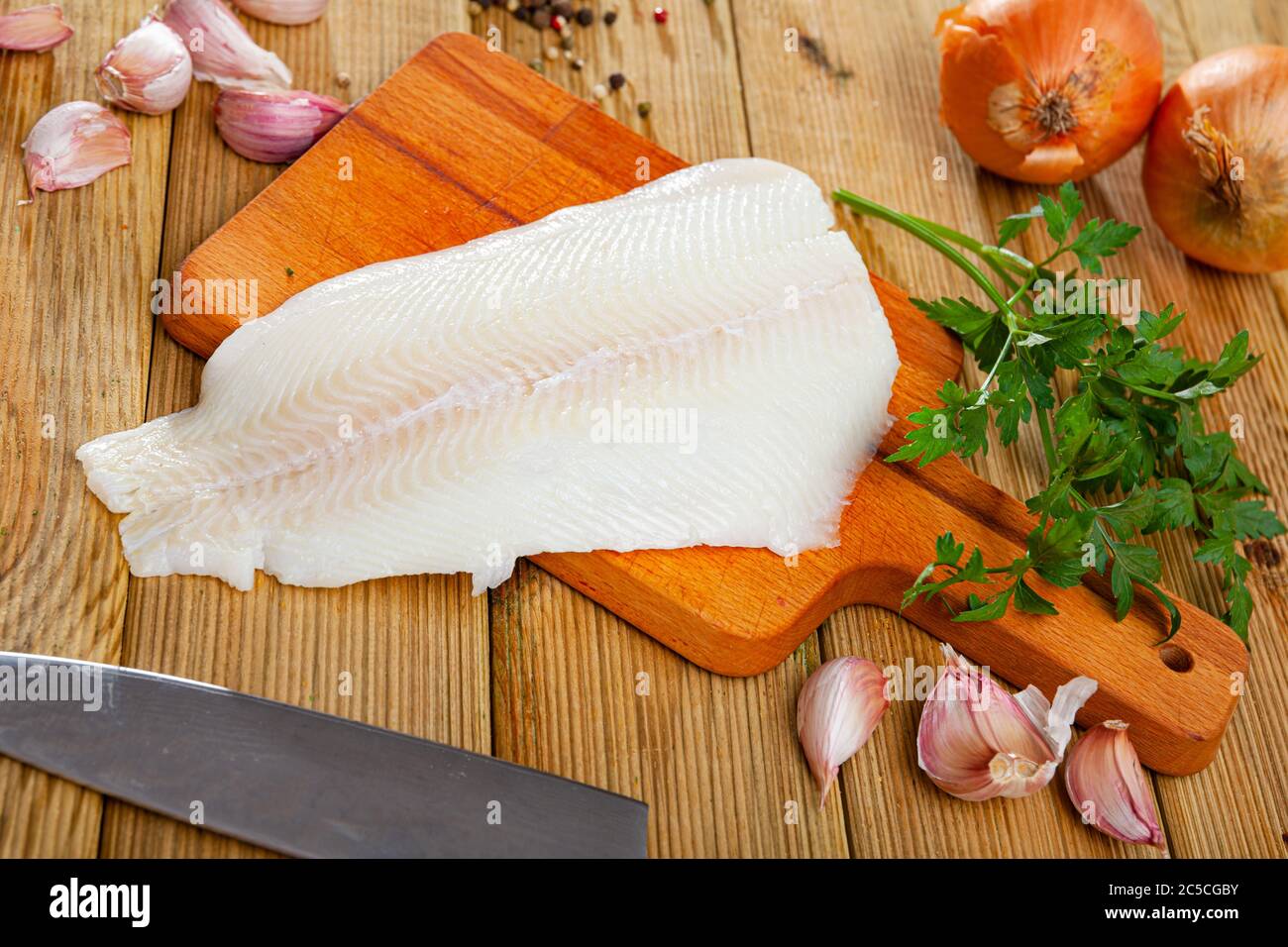 Image of fillet of raw halibut fish before cooking on wooden background ...