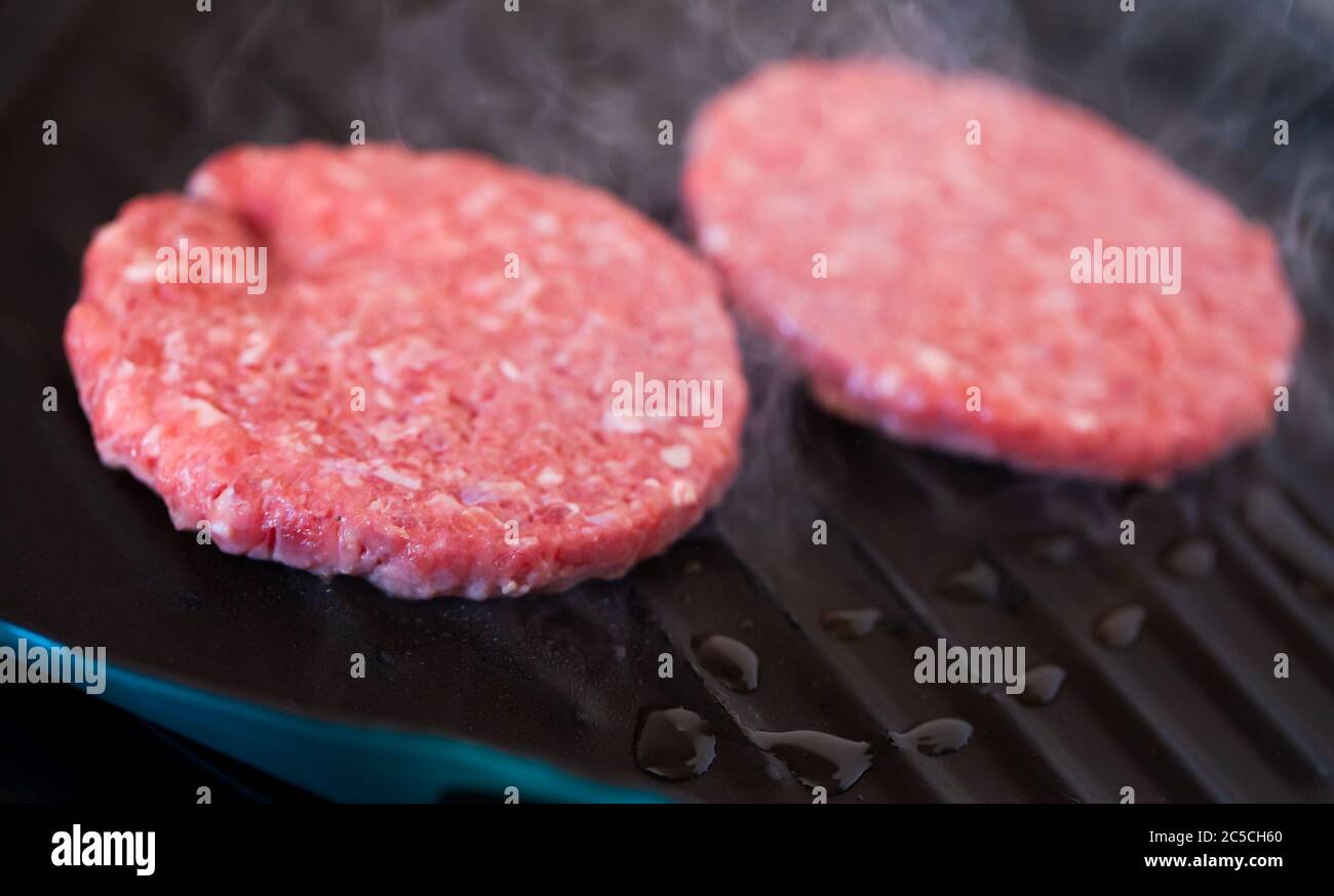 Cooking, barbecue and fast food concept — closeup of burger meat ...