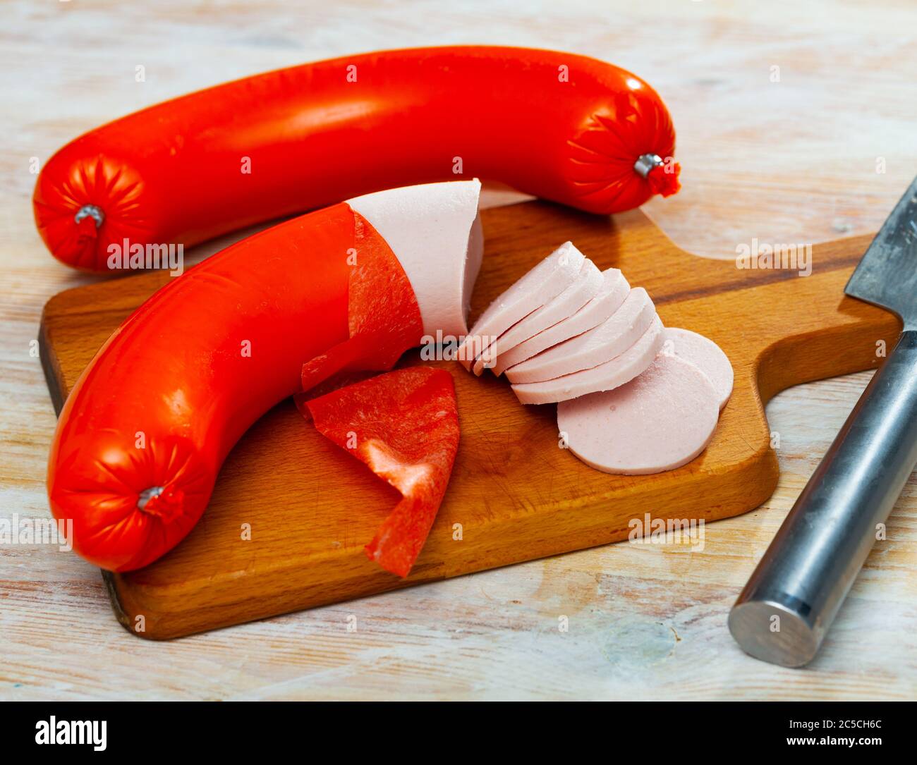 Traditional Italian cooked sausage Mortadella with sliced pieces on ...