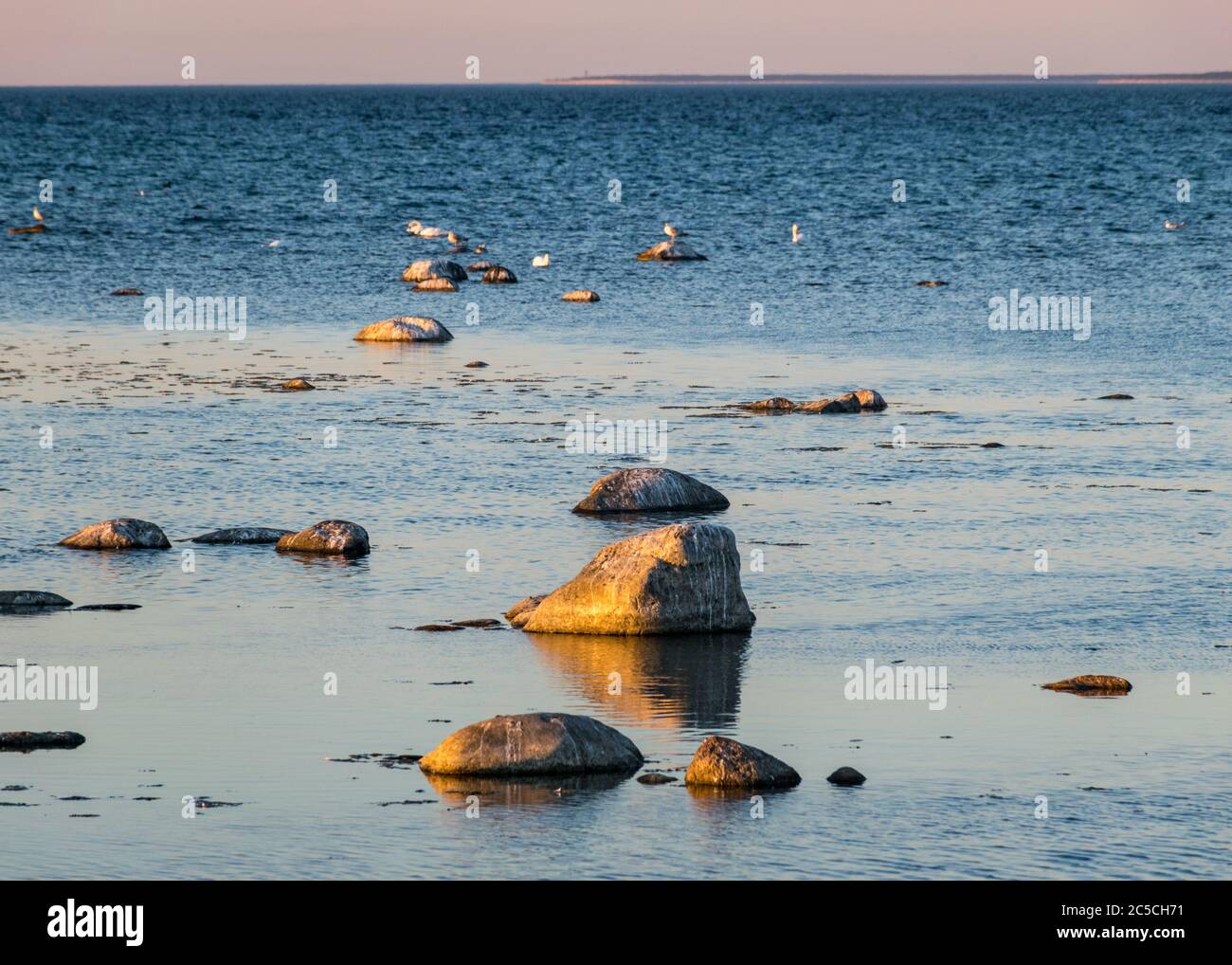 beautiful sunset landscape from a traditional rocky beach on the island ...