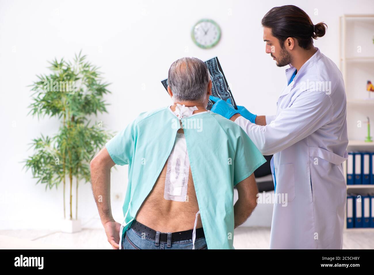 Old man visiting male doctor Stock Photo - Alamy