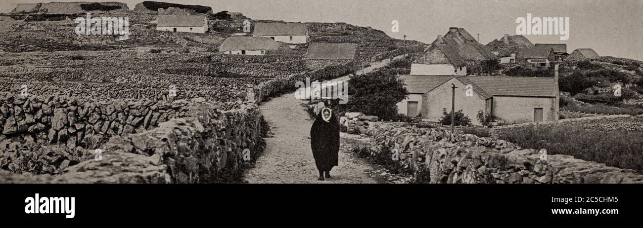 An early 1920's view of a woman in traditional dress walking down a ...
