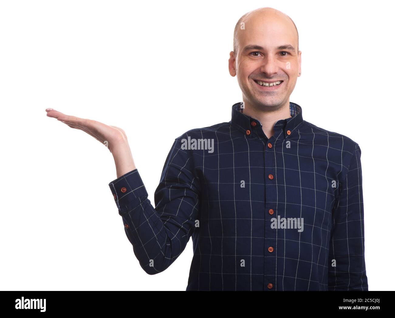 Handsome bald man smiling and presenting some product on his palm ...