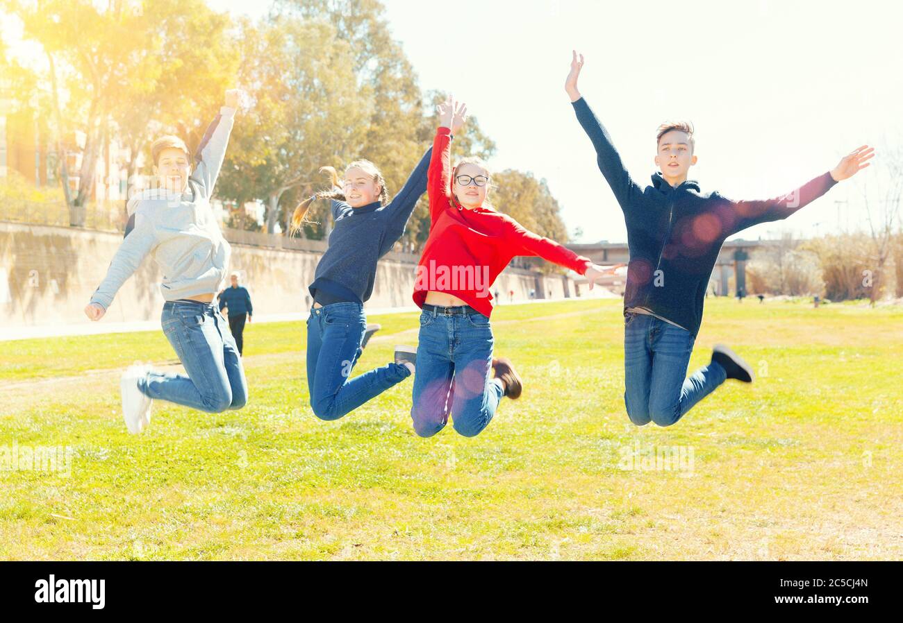 Portrait four happy friends jumping hi-res stock photography and images ...
