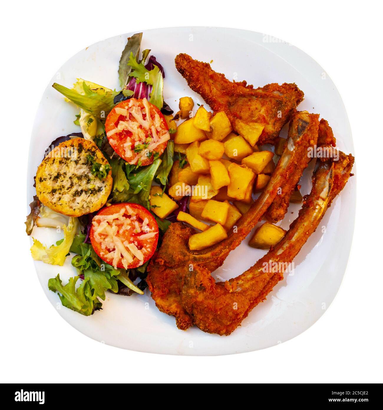 Breaded lamb rack served with fried potato, vegetable salad and toast ...