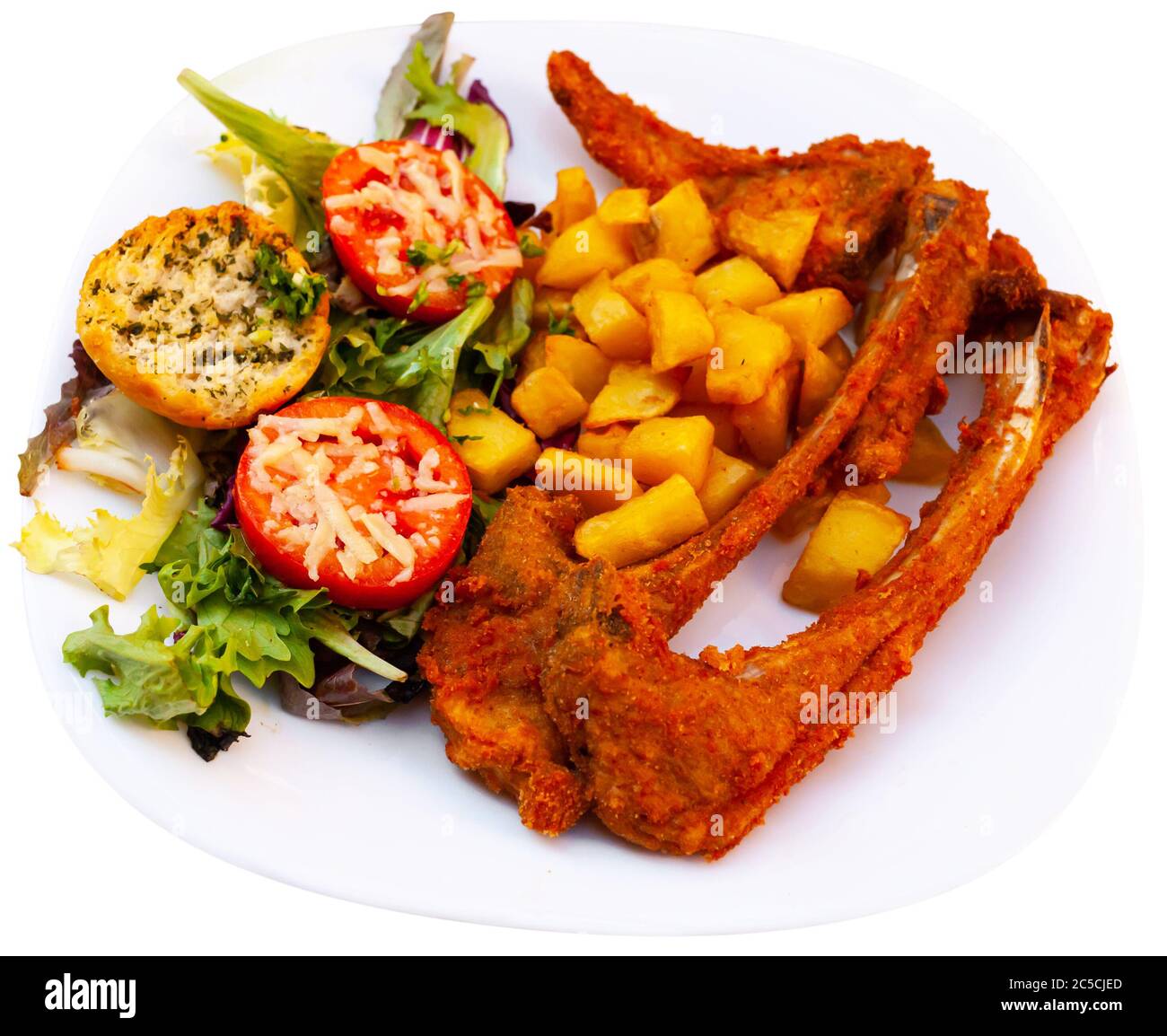 Breaded lamb rack served with fried potato, vegetable salad and toast ...