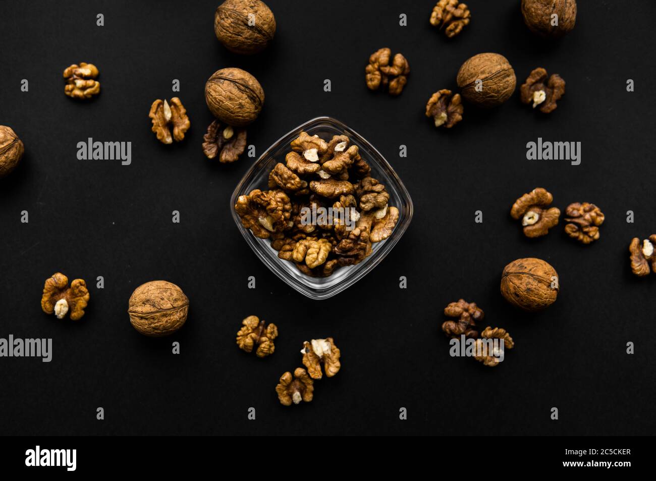 Walnut in a small plate with scattered shelled nuts which standing on a ...