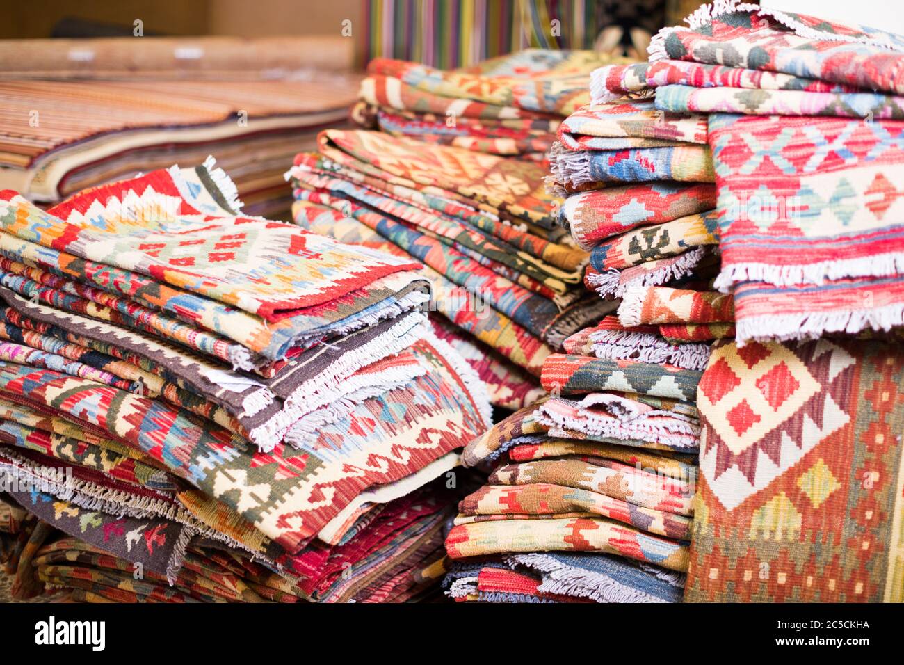 Stack of traditional colorful carpets in carpet shop, nobody Stock ...
