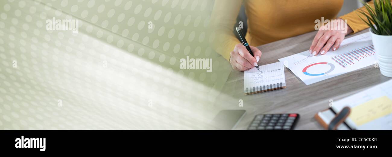 Businesswoman analyzing marketing data and taking notes; panoramic ...