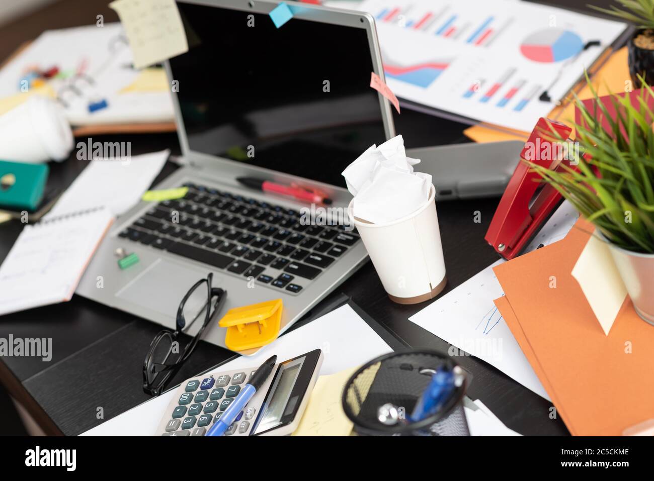 Messy and cluttered office desk Stock Photo - Alamy