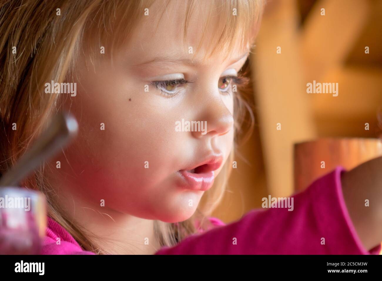 A girl's face expression while eating ice cream in close-up Stock Photo ...
