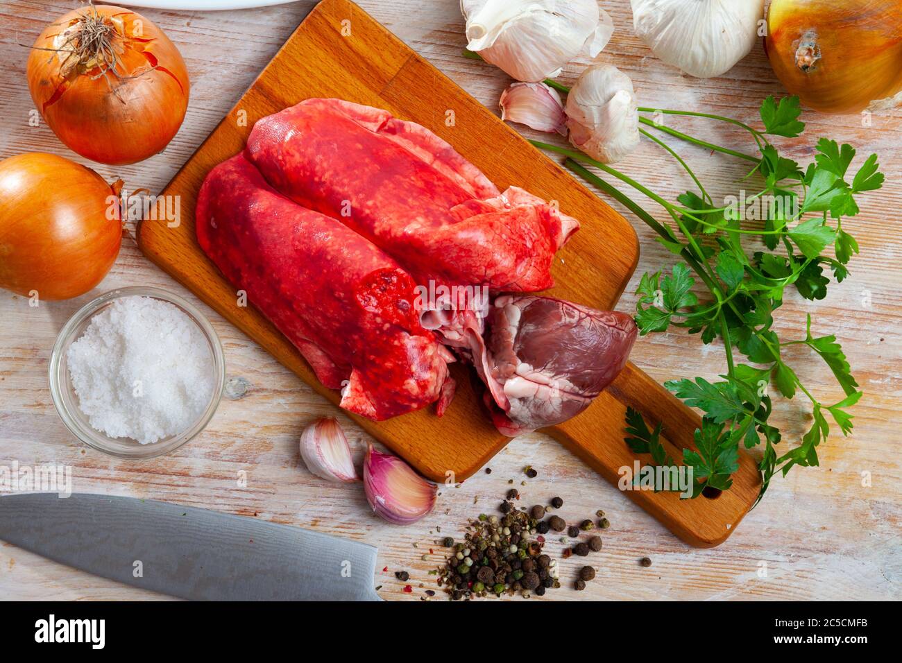 Raw lamb lungs and heart with natural ingredients before cooking Stock ...