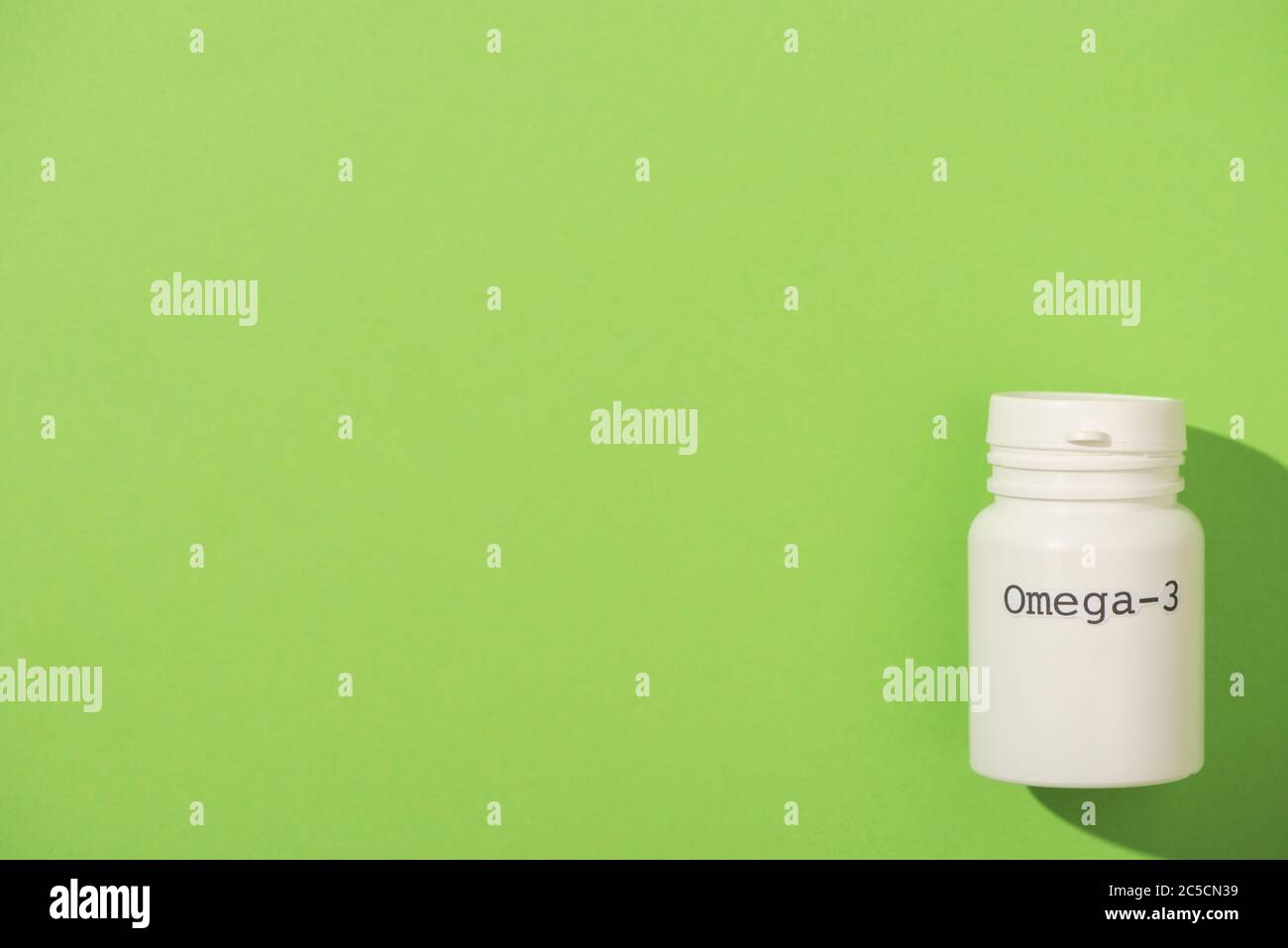 Top view of container with omega-3 lettering on green background Stock ...