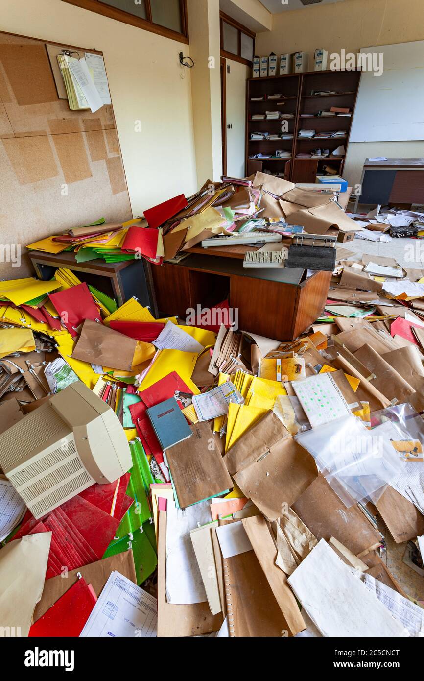 office full of papers and folders due to crisis Stock Photo - Alamy