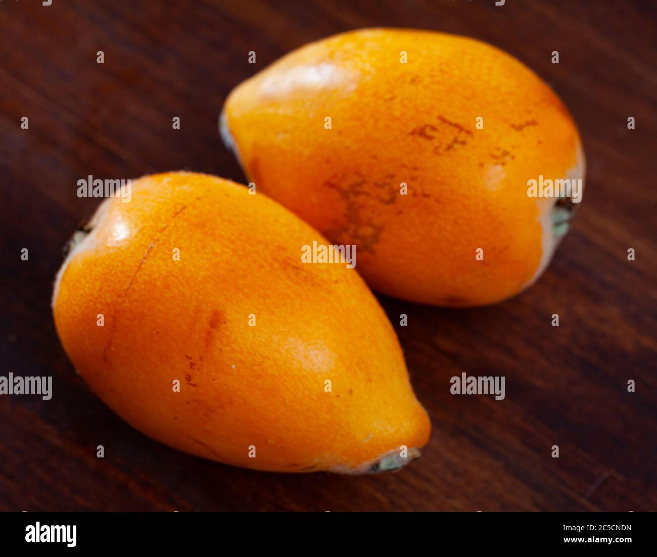 Ripe medlar fruits nispero on wooden surface, nobody Stock Photo - Alamy