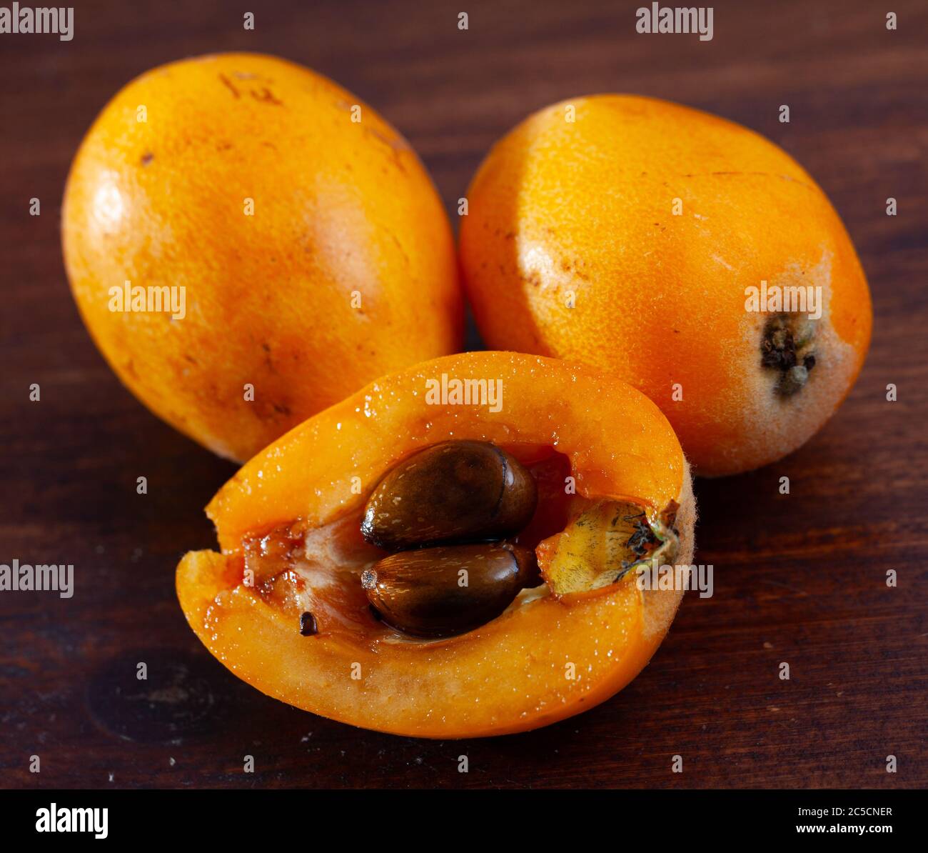 Ripe medlar fruits nispero on wooden surface, nobody Stock Photo - Alamy