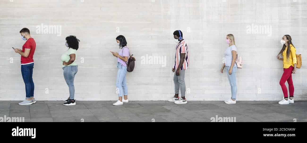 Young people from different cultures and race waiting in queue outside ...