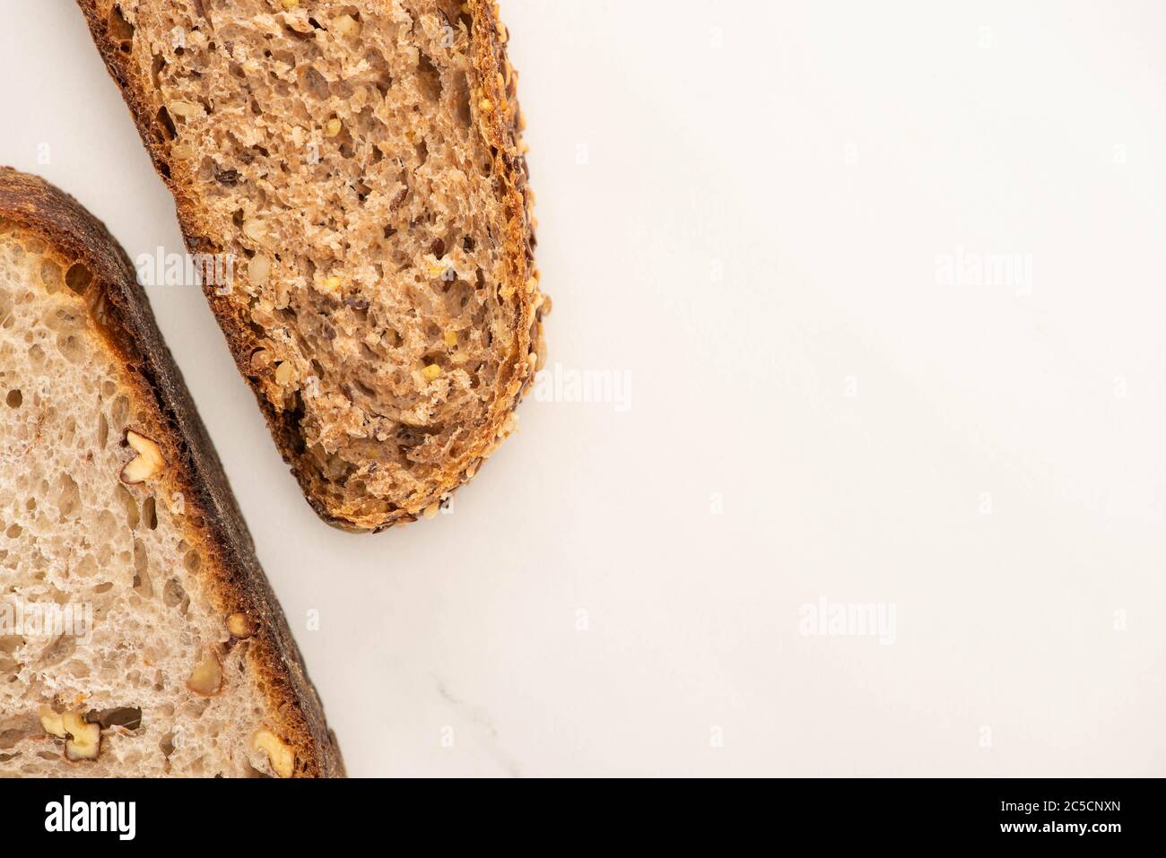 top view of fresh brown bread slices on white background Stock Photo - Alamy