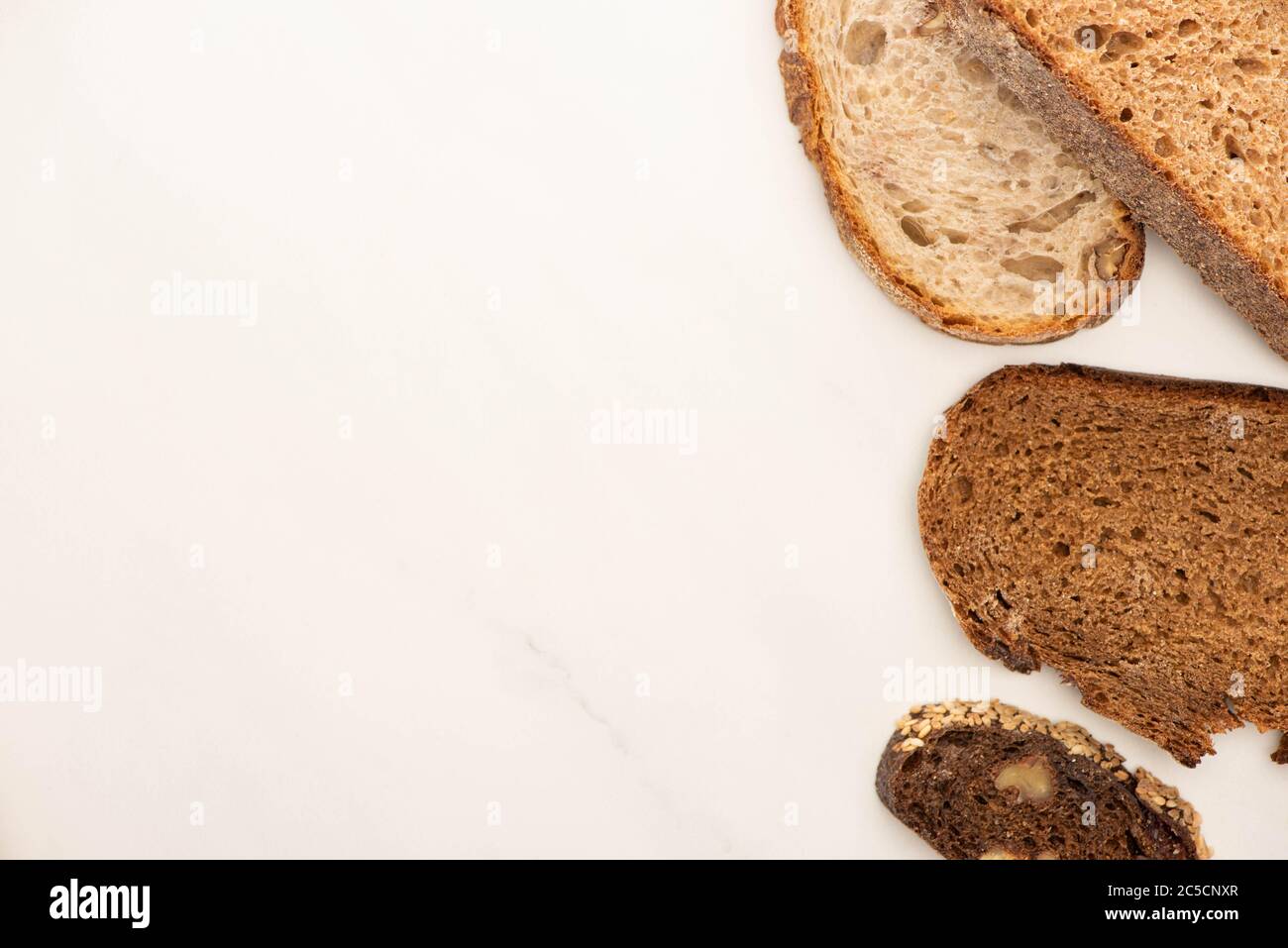 top view of fresh whole grain bread slices on white background Stock ...