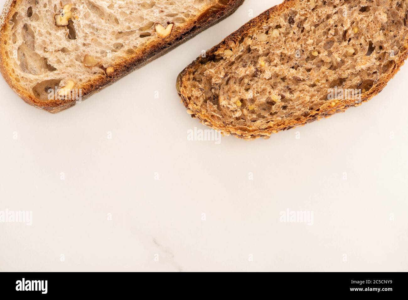 top view of fresh brown bread slices on white background Stock Photo - Alamy