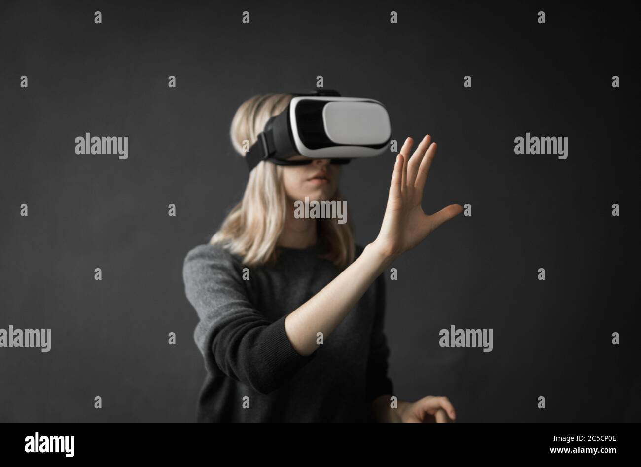 Young woman wearing virtual reality goggles headset, vr box. Connection ...