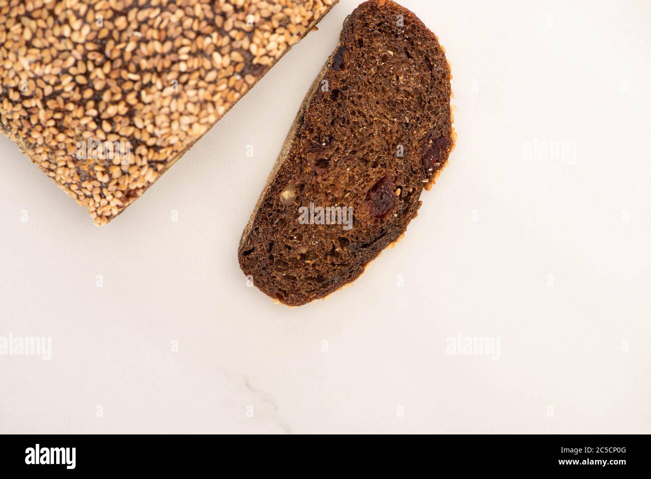 top view of fresh brown bread slice and loaf on white background Stock ...