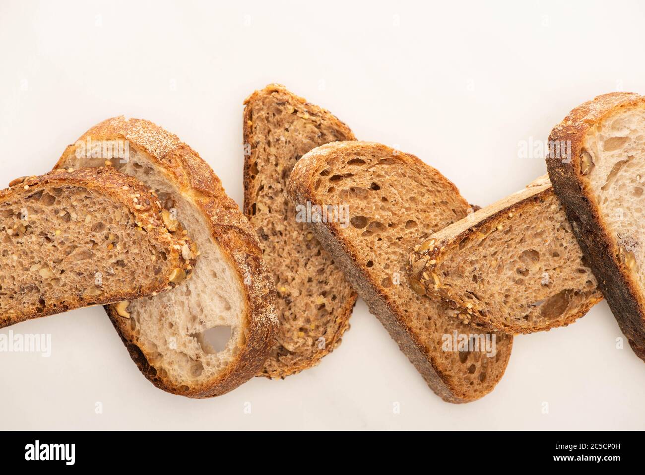 top view of fresh whole grain bread slices on white background Stock ...