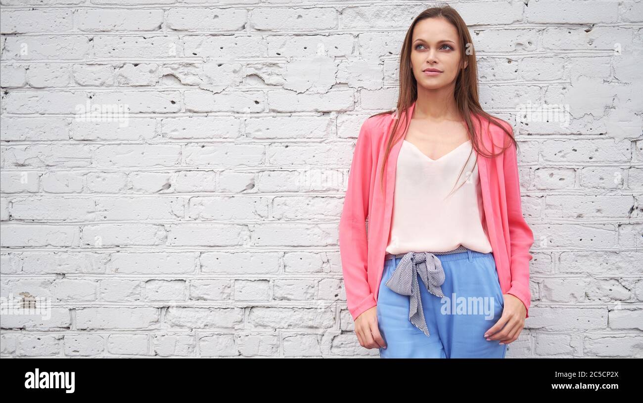 Attractive girl standing near wall hi-res stock photography and images ...