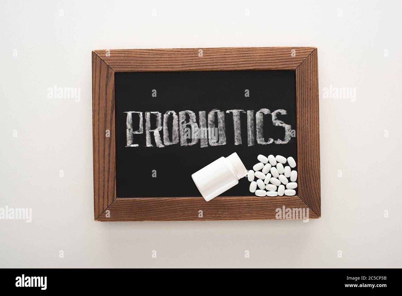 top view of chalkboard with probiotics lettering with pills and ...