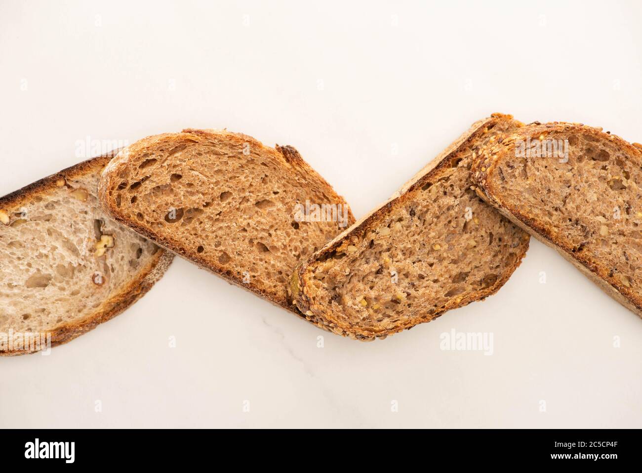 top view of whole grain bread slices on white background Stock Photo ...