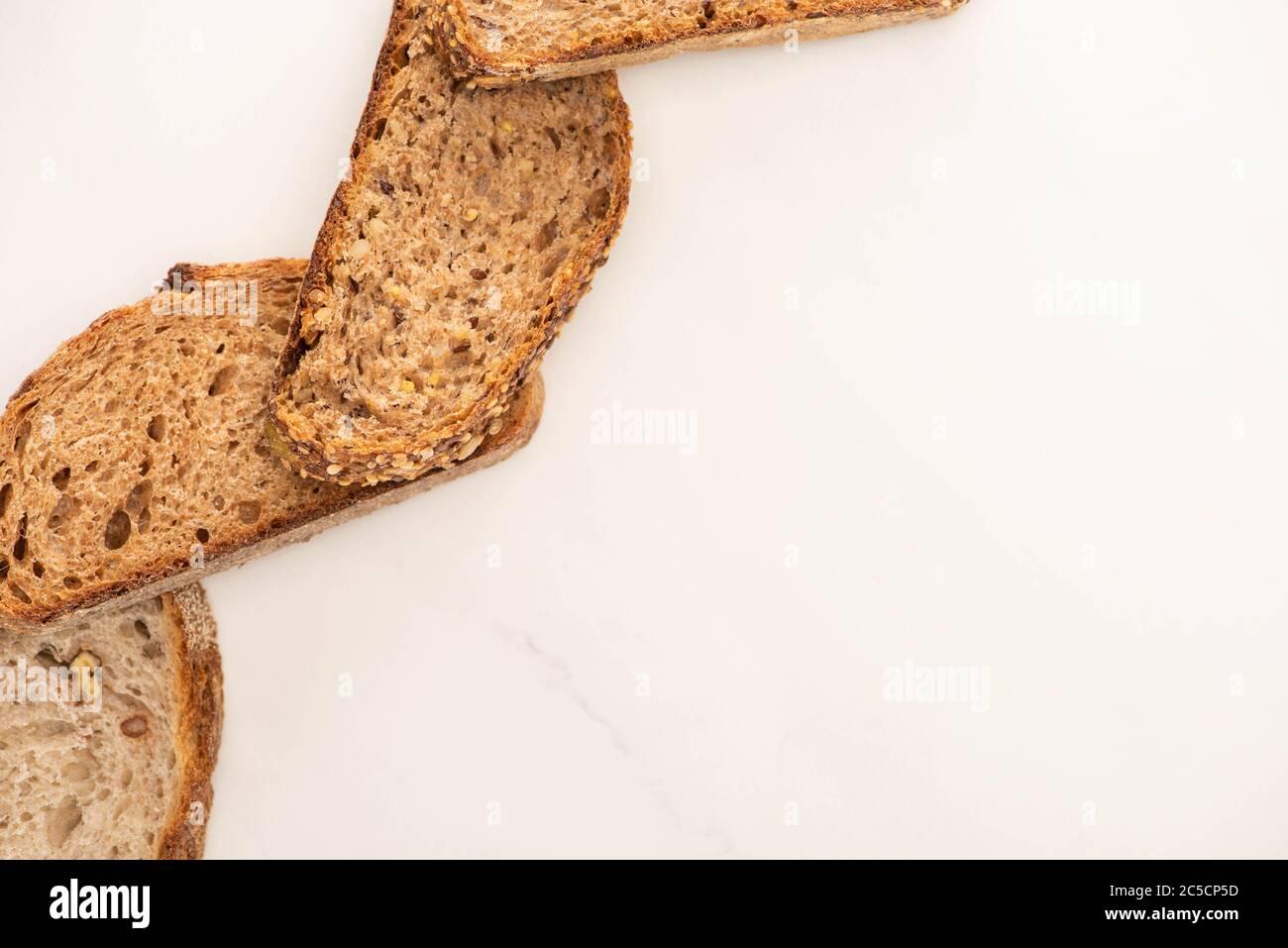 top view of whole grain bread slices on white background with copy ...