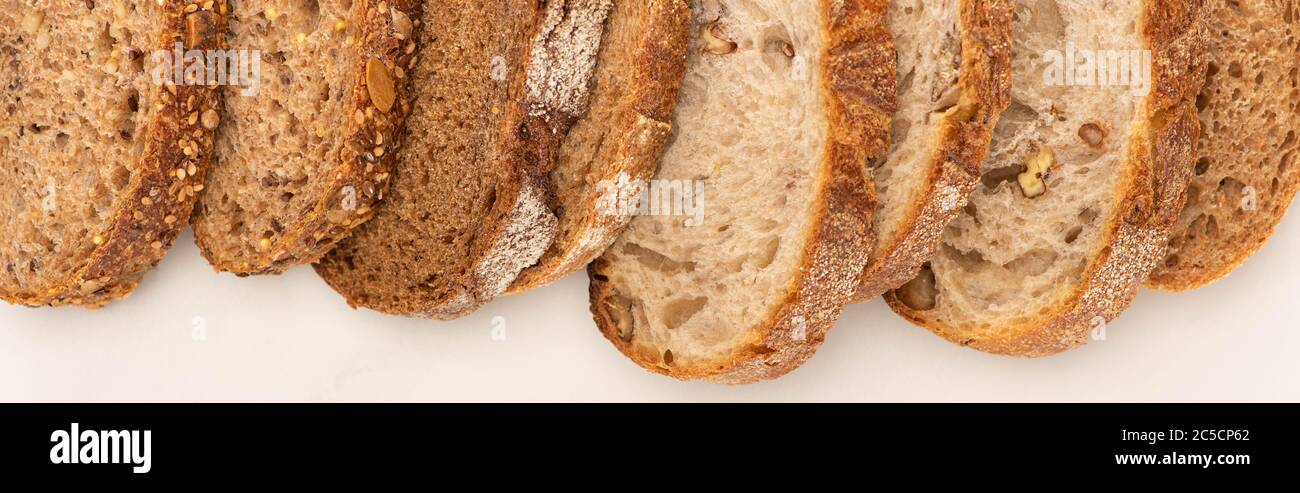 top view of fresh whole wheat bread slices on white background ...