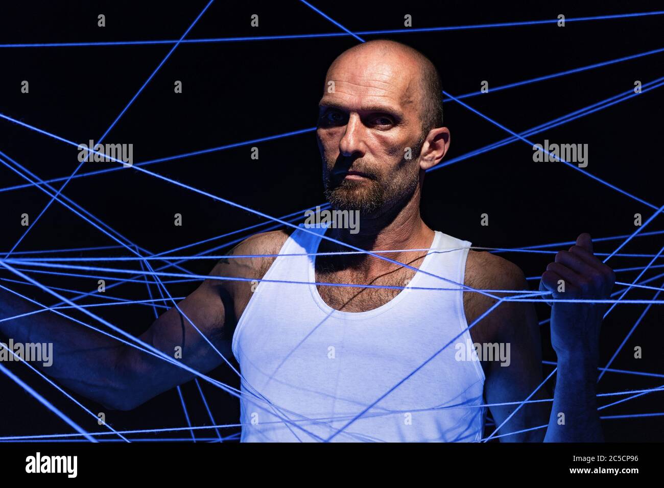 Photo of adult man tangled in white rope in neon light Stock Photo - Alamy