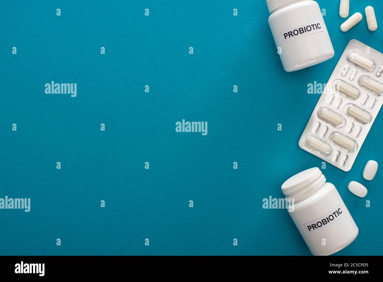 top view of containers with probiotic lettering, pills and blister pack ...