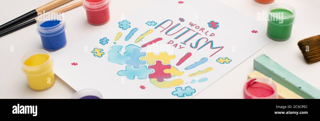 panoramic shot of card with World Autism Day lettering and painting of ...