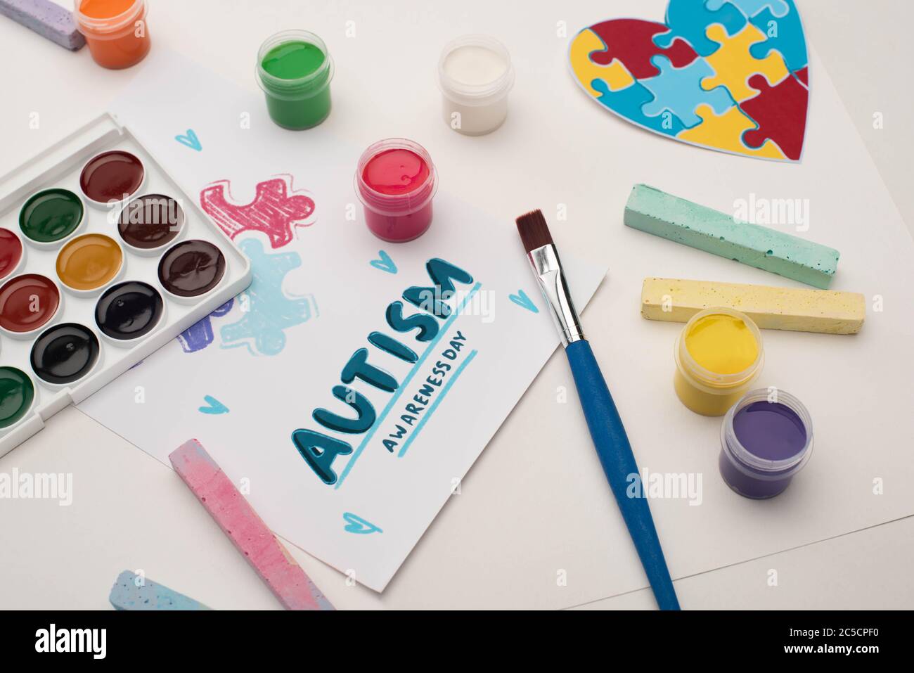 card with Autism Awareness Day lettering and painting of puzzle on ...