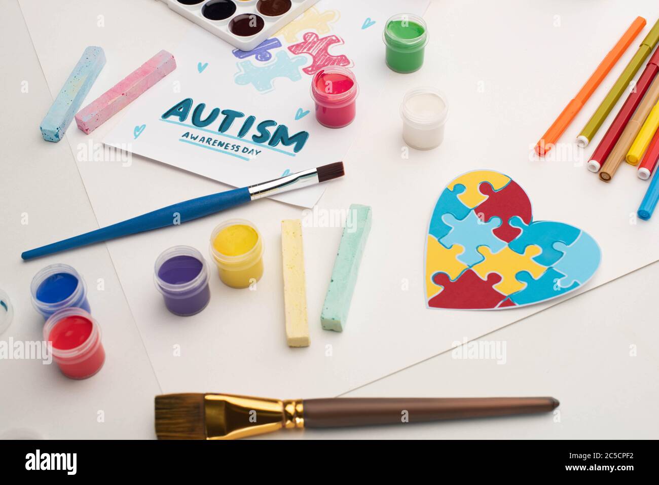 card with Autism Awareness Day lettering and painting of puzzle on ...