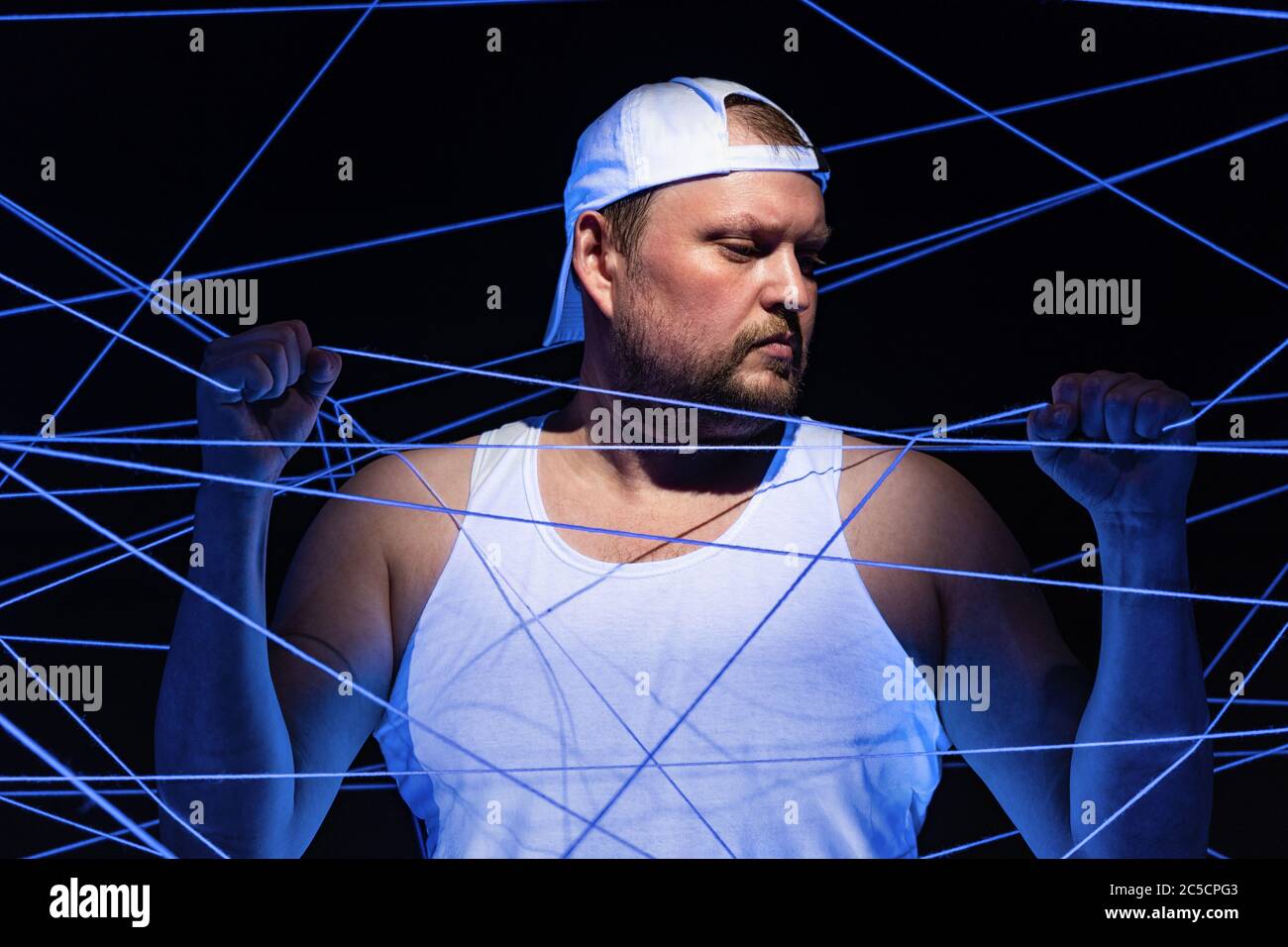 Picture of stout man with white threads in neon light Stock Photo - Alamy