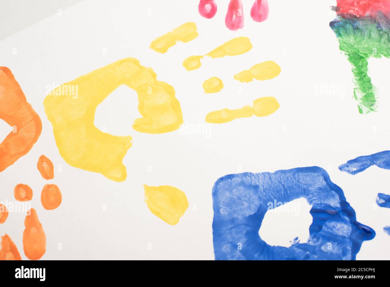 top view of colorful handprints on white for World Autism Awareness Day ...