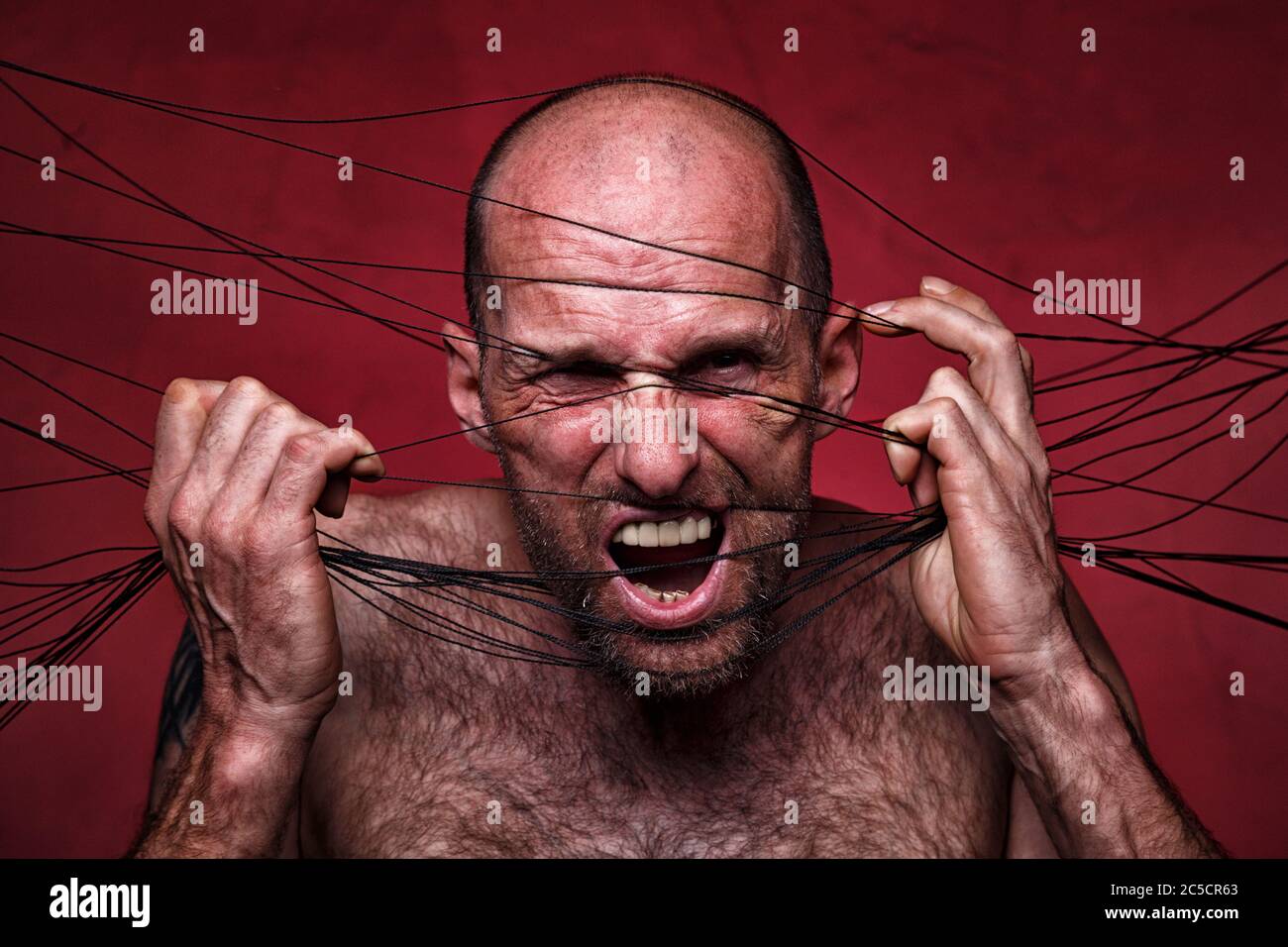 Mad bald man in black hi-res stock photography and images - Alamy