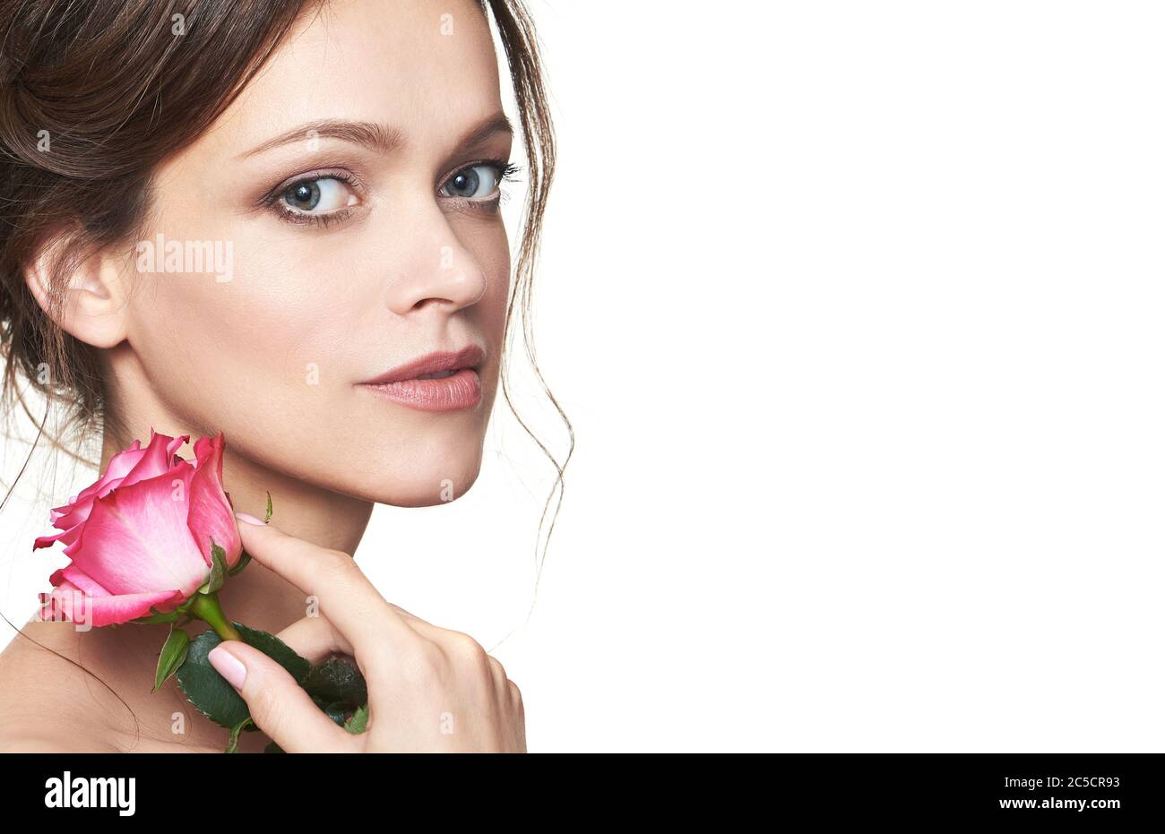 Beautiful woman with clear smooth skin holds a red rose flower. Skin ...
