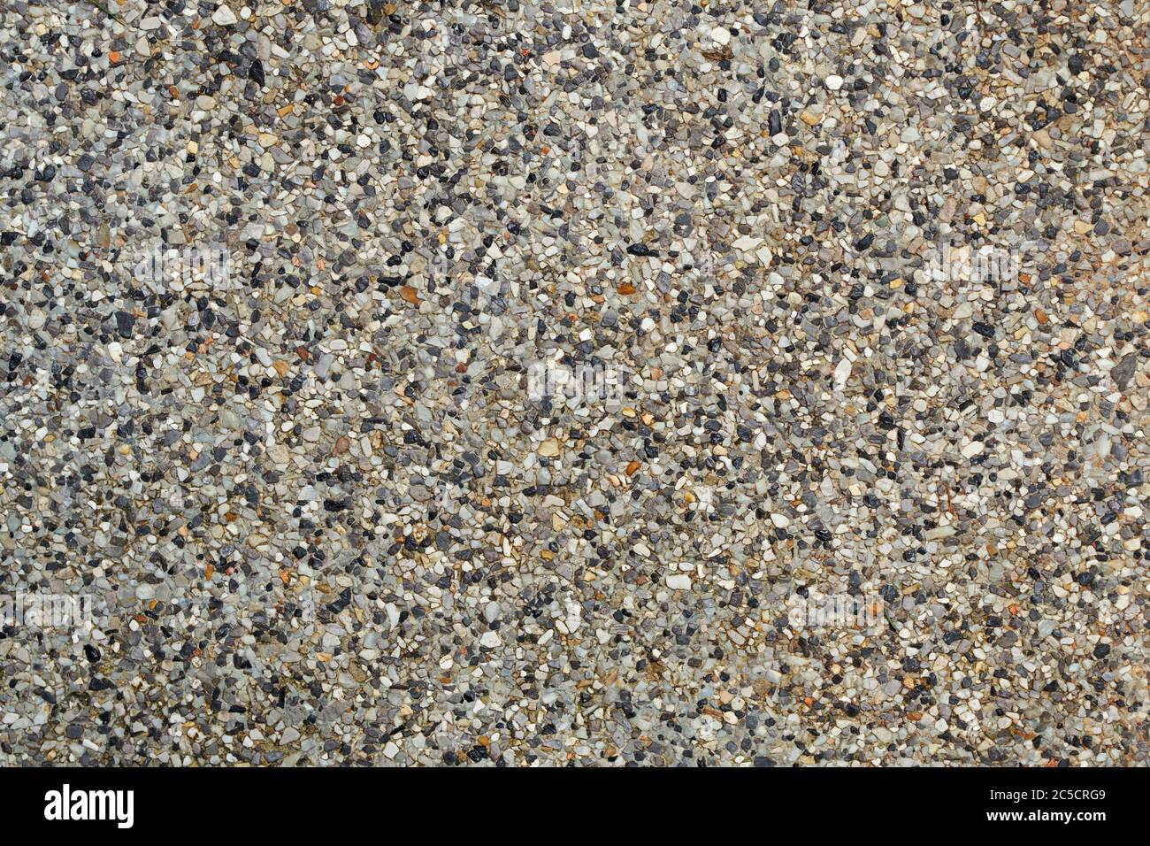 Small stones in concrete floor. Background and texture Stock Photo - Alamy