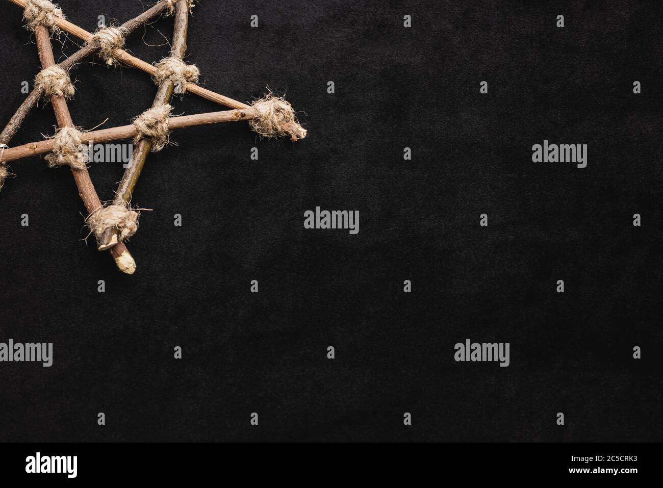 top view of pentagram with wooden sticks on black Stock Photo - Alamy