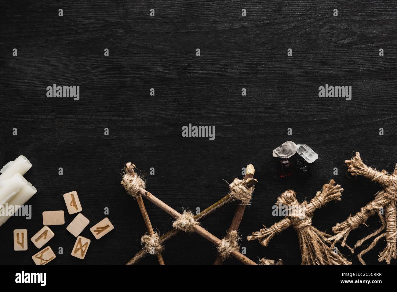 top view of voodoo dolls, ancient runes, pentagram, crystals and ...