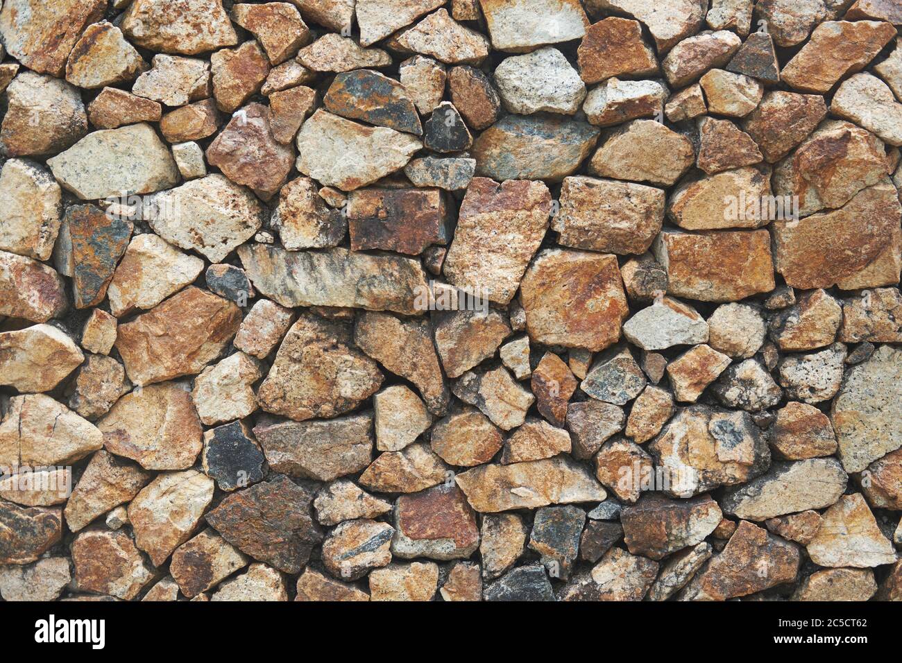 Fragment of a wall from a chipped stone. Texture and background for ...