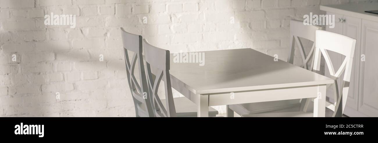 panoramic shot of chairs near table in kitchen Stock Photo - Alamy